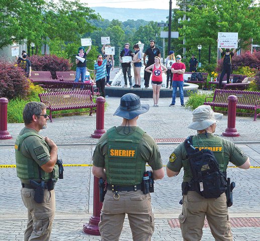 Peaceful protest watched over by strong law enforcement presence ...