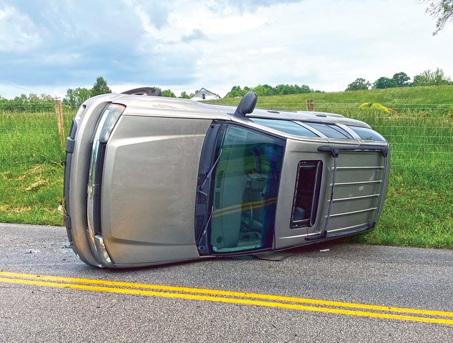 Driver's arm pinned between car, road - Southern Standard